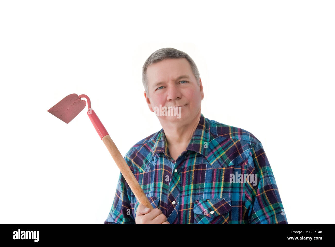 Portrait of mature gardener holding a hoe isolated on a white ...