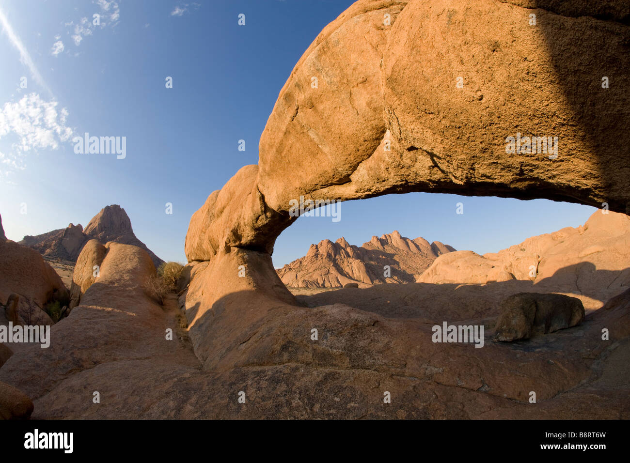 Africa Namibia Usakos Setting sun lights granite arch and rock ...