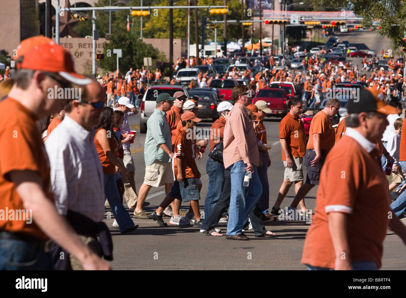 Football fans crossing the street before a University of Texas ...