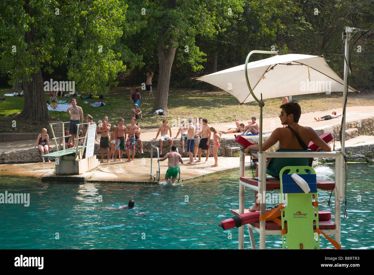 A lifeguard looks over Barton Springs Pool in Austin, Texas during the ...