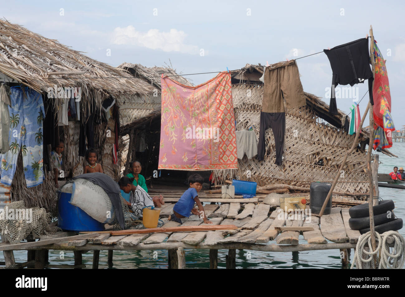 Bajau Laut family on wooden house platform Pulau Bodgaya Semporna Sulu ...