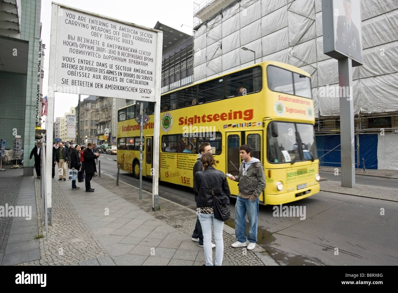 City bus passes close to the Checkpoint Charlie in Berlin. Germany ...