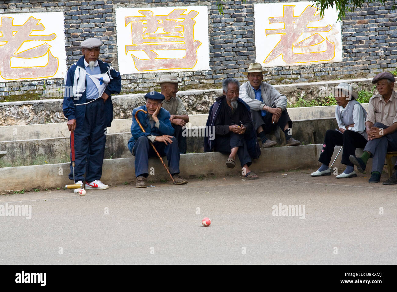 Locals watching a cricket game in the village of Baisha, Yunnan ...