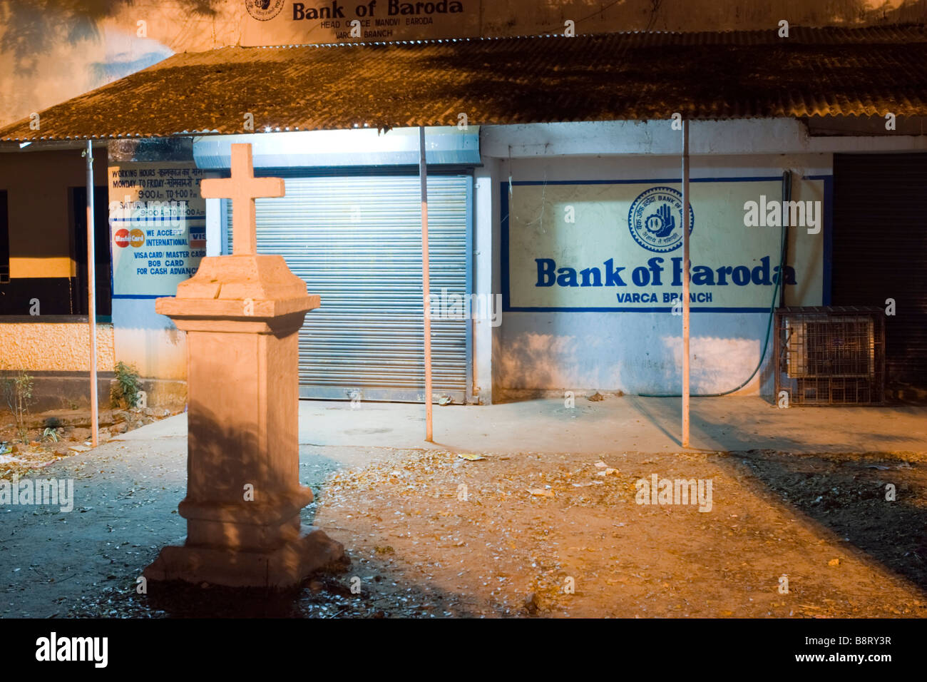 Varca dirty small closed bank office at night with small cross infront ...