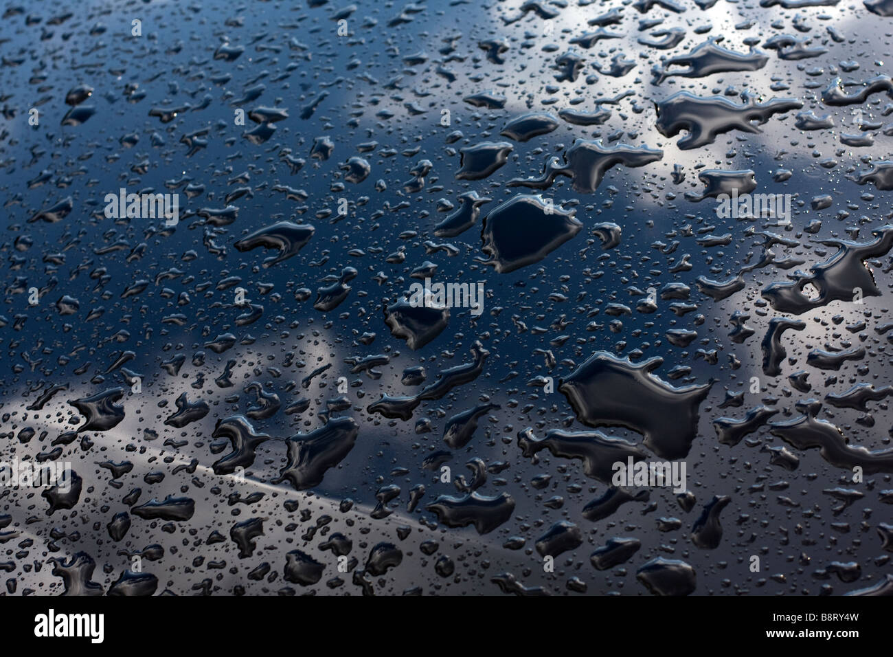 water drops in a car surface with some clouds reflected Stock Photo - Alamy