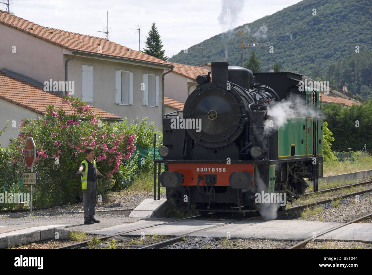 steam engine, Train a vapeur des Cevennes, man at a railroad crossing ...