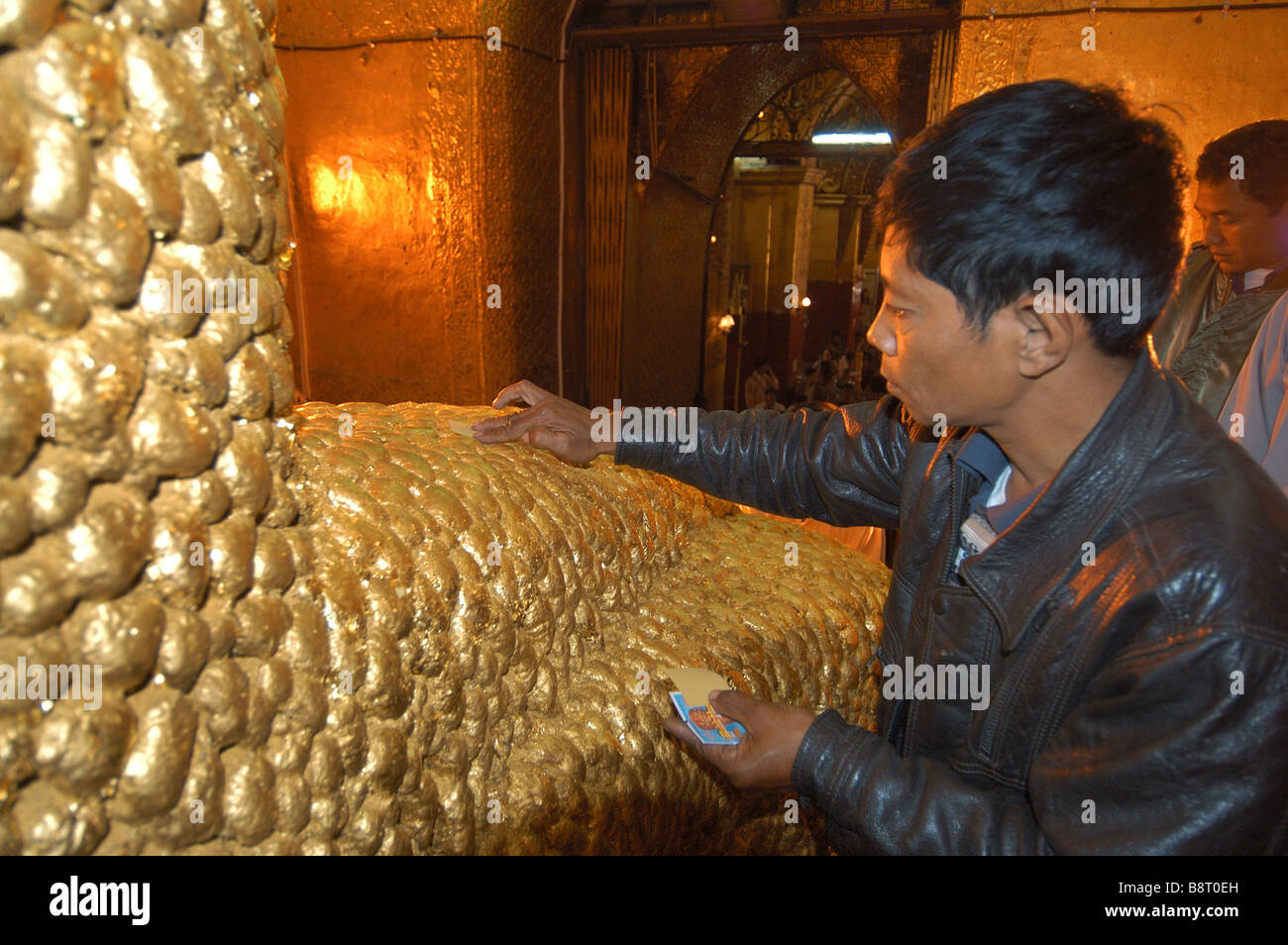restoration of a Buddha statue with beaten gold, Burma Stock Photo - Alamy