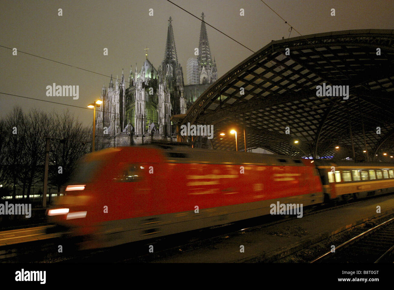 driving train in front of Cologne Cathedral by night, Germany, North ...