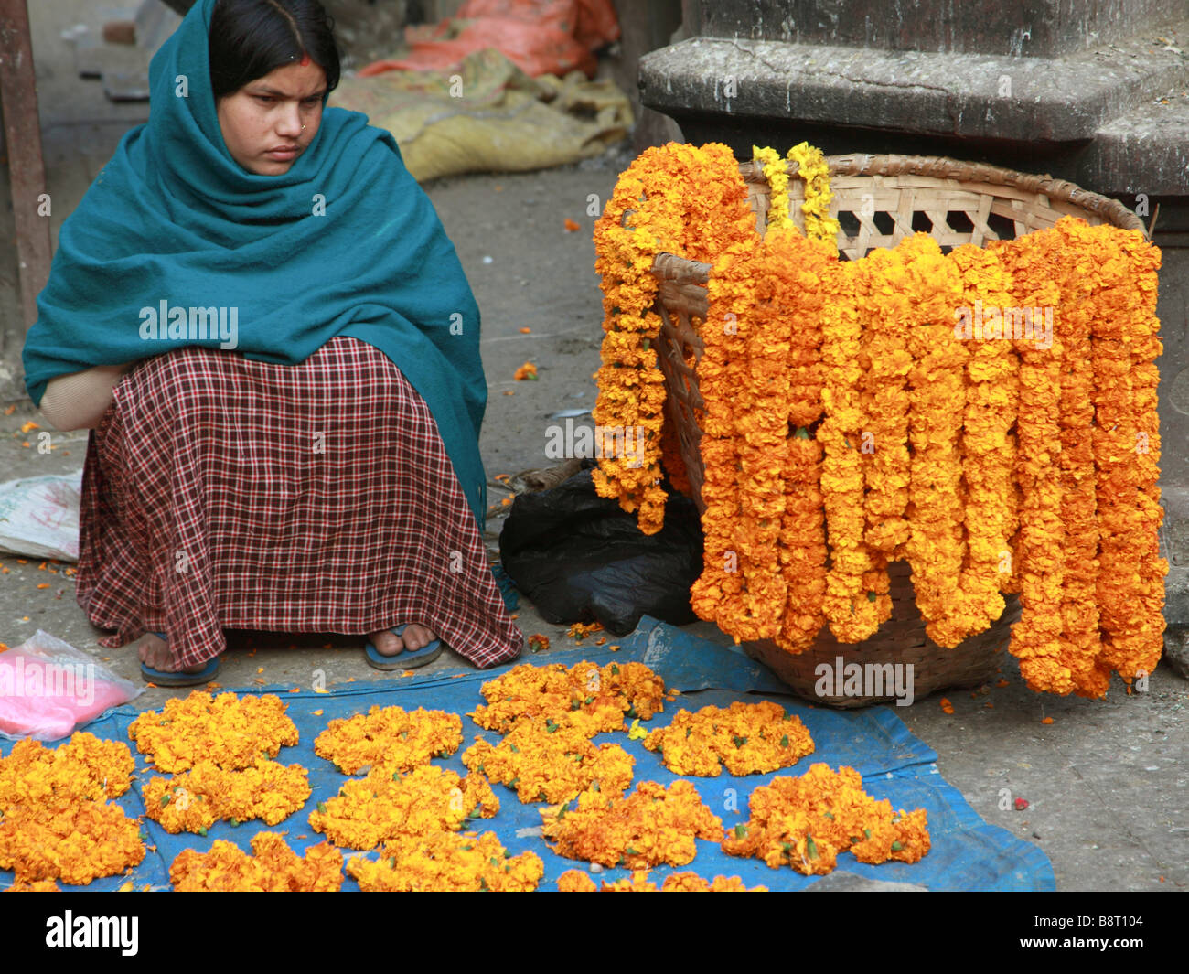 Nepal Kathmandu Jana Bahal temple vendor of flower offerings Stock ...