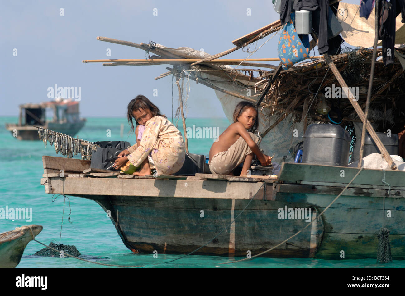 Two young Bajau Laut girls on stern of houseboat Pulau Sibuan Semporna ...