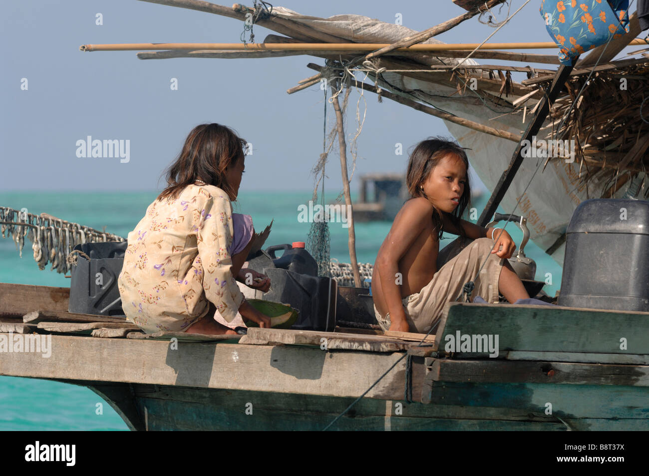 Two young Bajau Laut girls on stern of houseboat Pulau Sibuan Semporna ...
