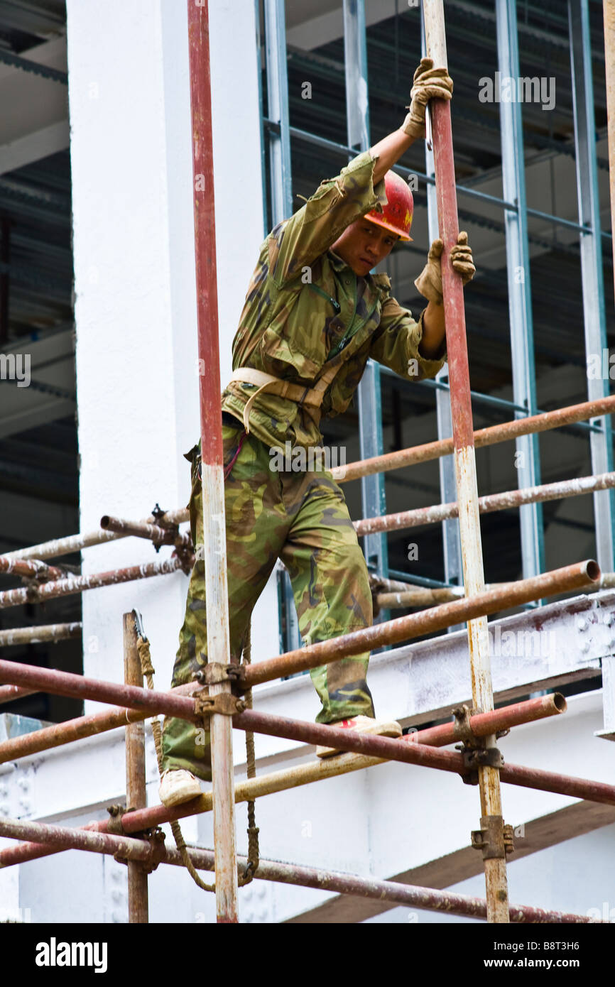 A construction worker on his scaffolding in Kuming, Yunnan province ...