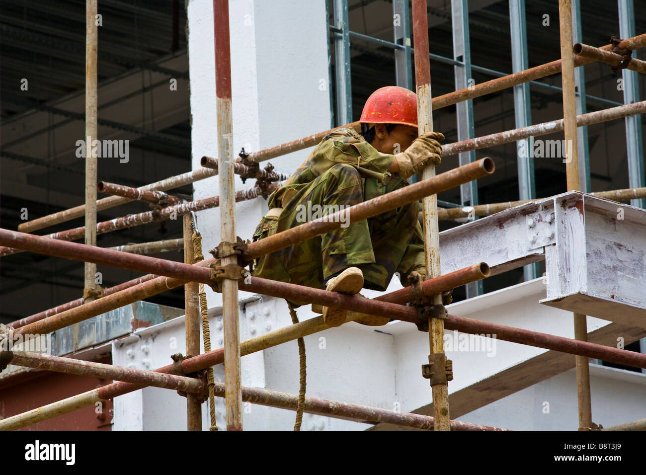 A construction worker on his scaffolding in Kuming, Yunnan province ...