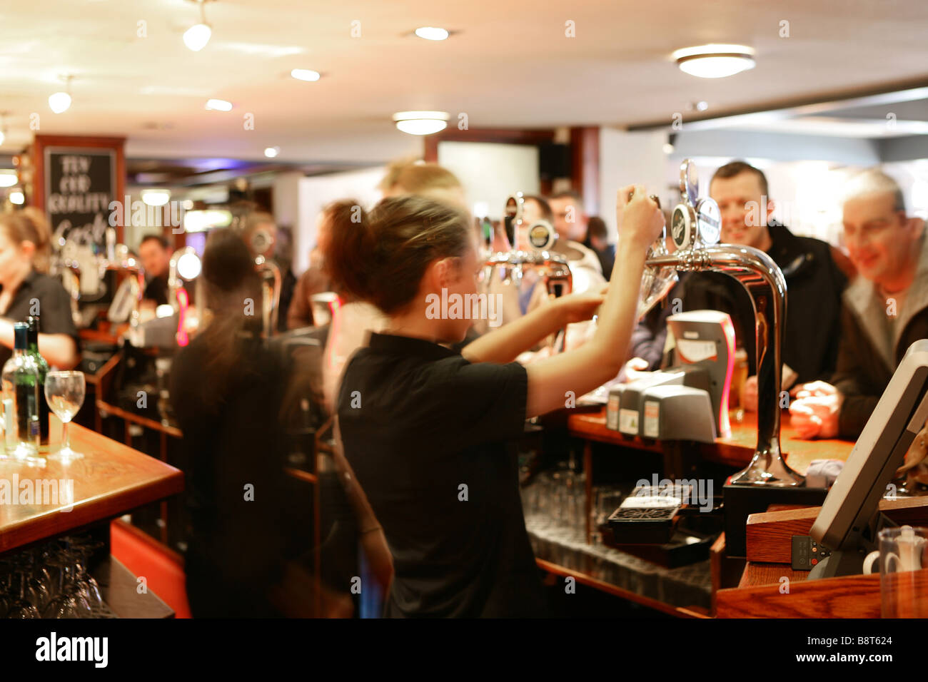 Bar waitress serving with alcoholic drinks Stock Photo - Alamy