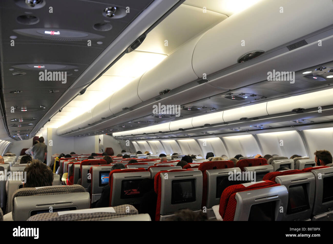 Plane passenger interior view in Virgin Atlantic Airbus jet airplane cabin passengers inflight ...