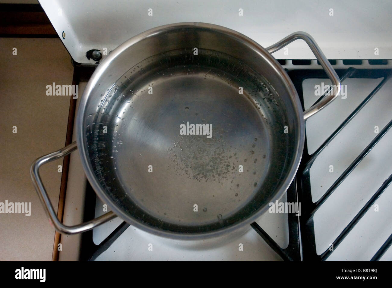 almost boiling water in a pan with salt on the bottom ready to cook ...