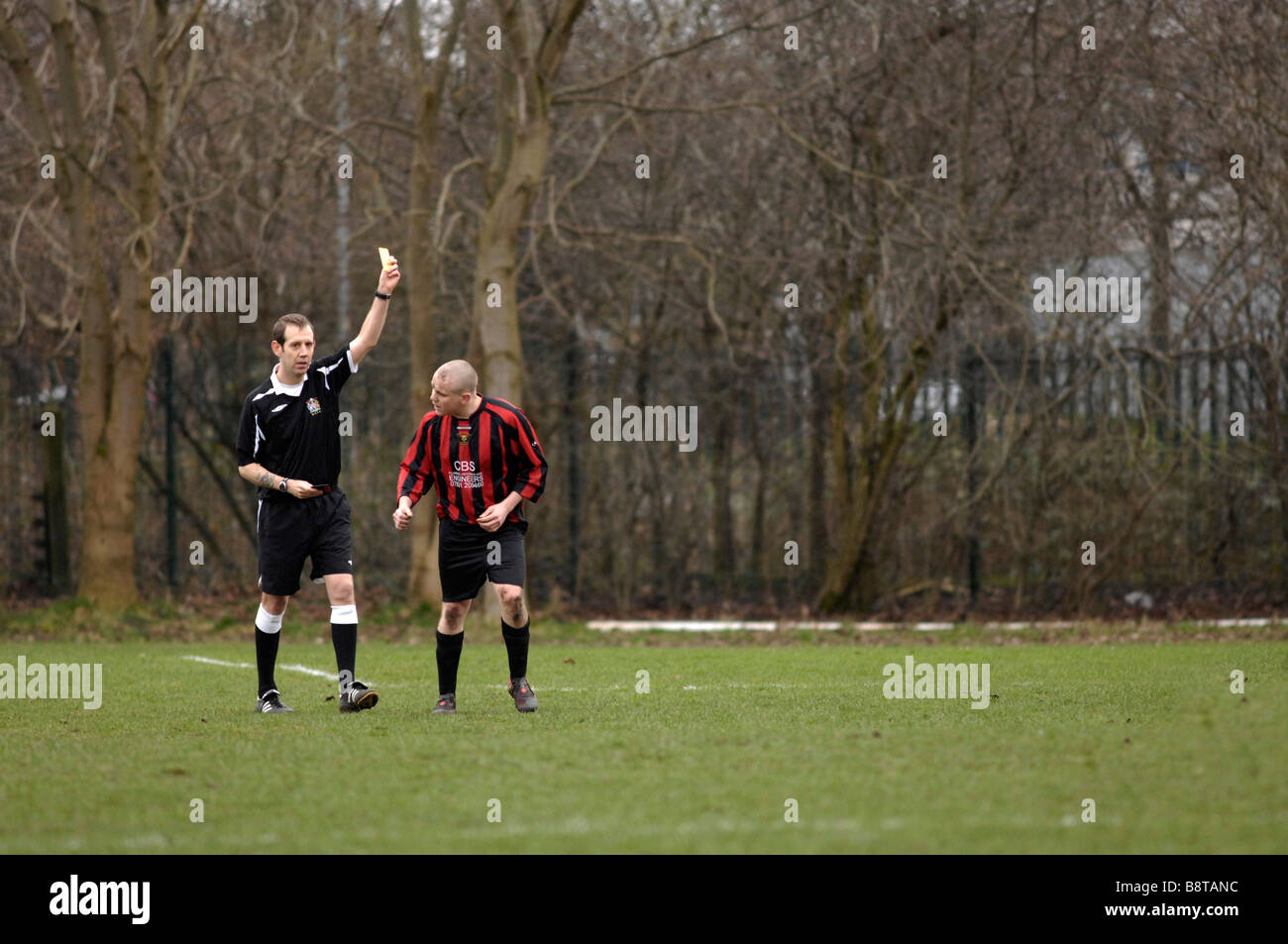 referee shows a football player the yellow card for an offence Stock ...