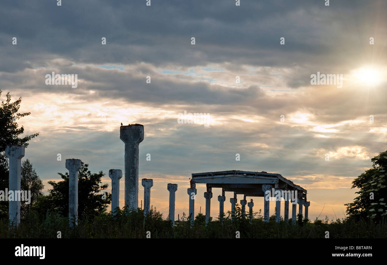 supports of destroyed farm building on twilight overcast sky background ...