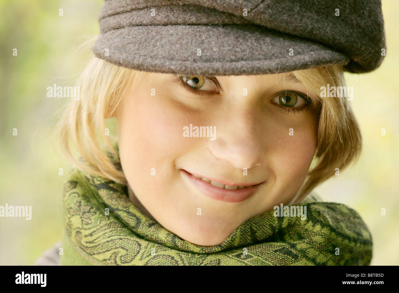 young blond girl with cap, smiling Stock Photo - Alamy