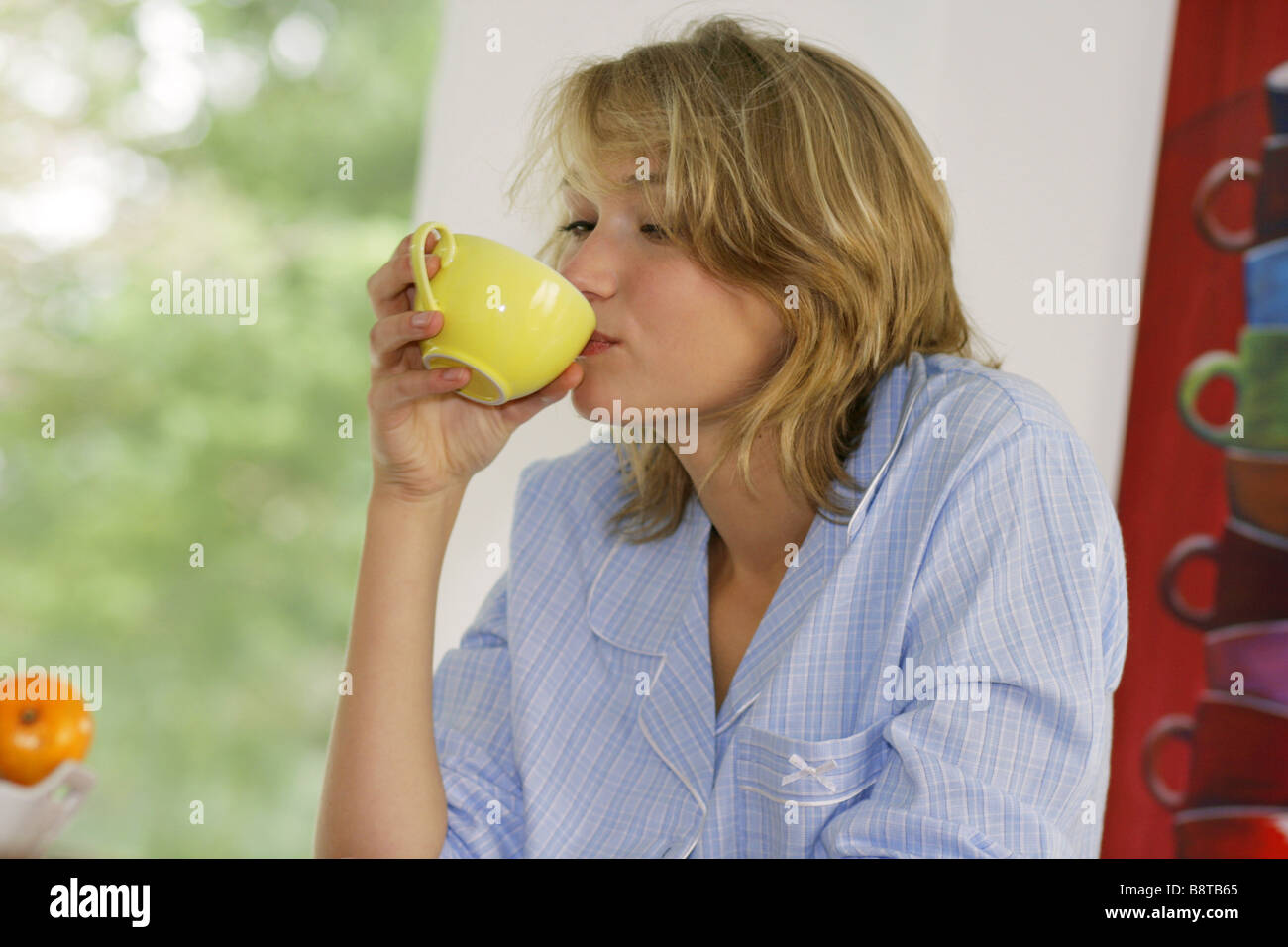 young woman with the first cup of coffee in the morning Stock Photo - Alamy