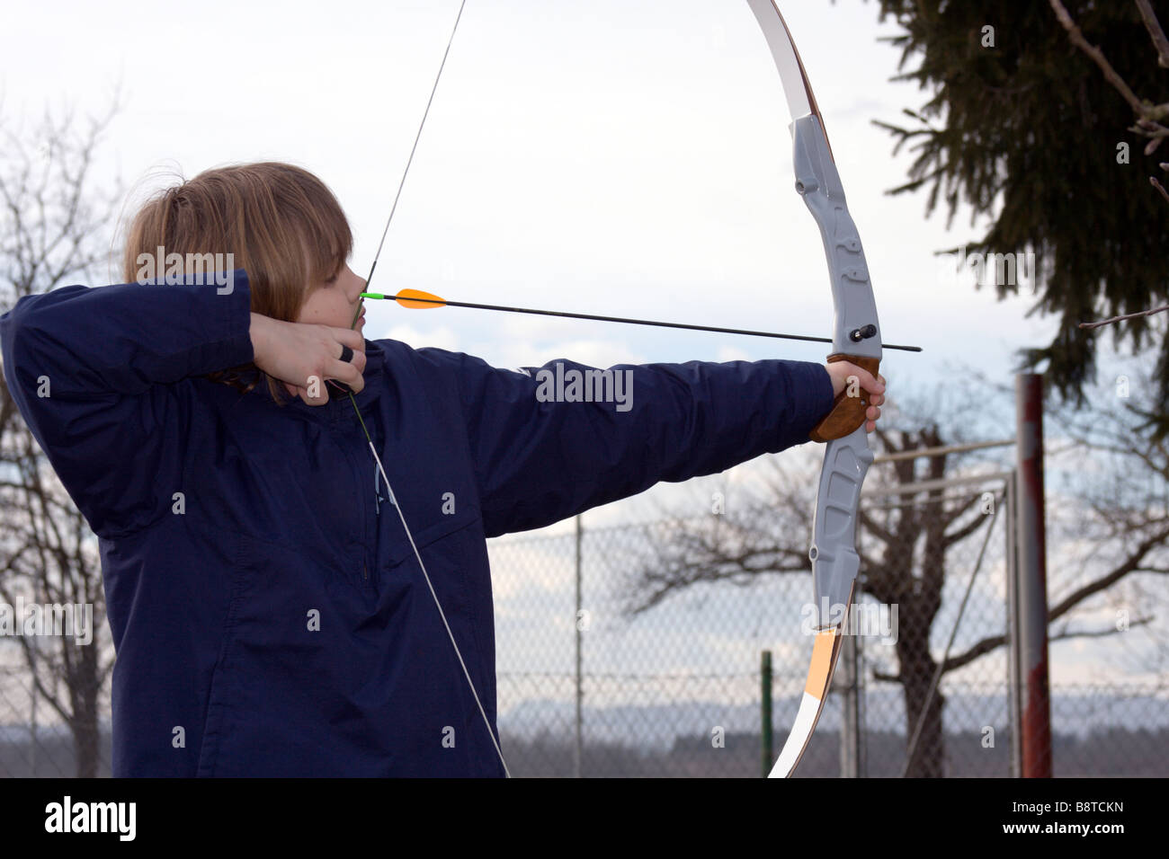Teenage boy archer practicing in the back-yard Stock Photo - Alamy