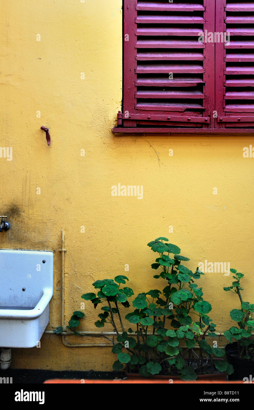 Shuttered window yellow wall exterior hi-res stock photography and ...