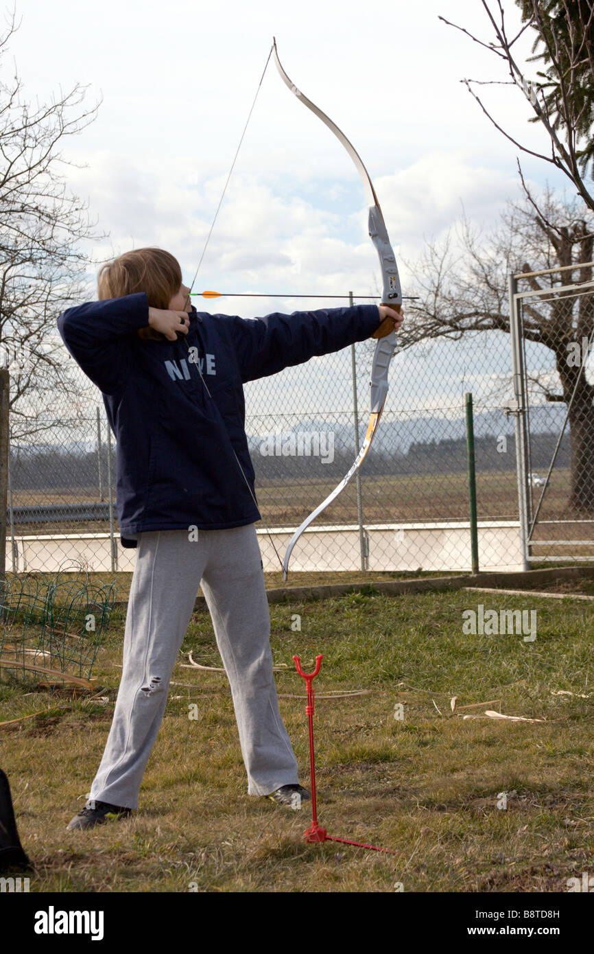 Teenage boy archer practicing in the back-yard Stock Photo - Alamy