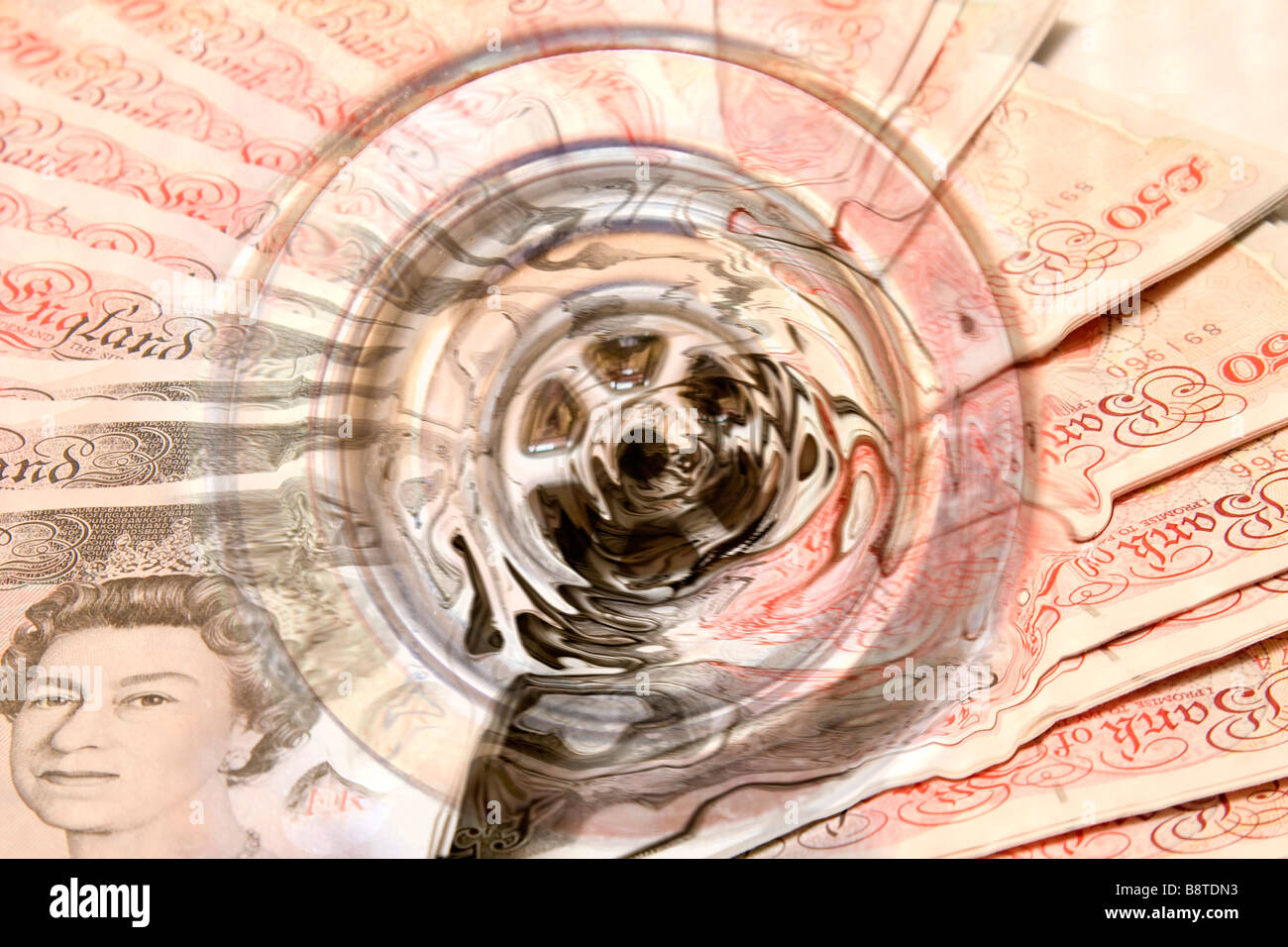 Money pouring down the drain or plug hole or wasting money Stock Photo ...