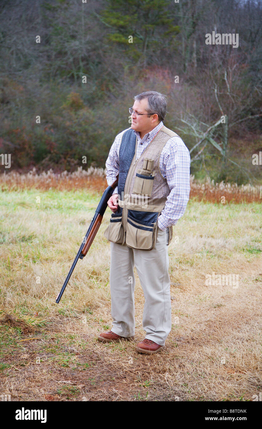 FULL LENGTH VIEW OF SPORTING CLAY SHOOTER GUN UNDER ARM POINTING DOWN ...