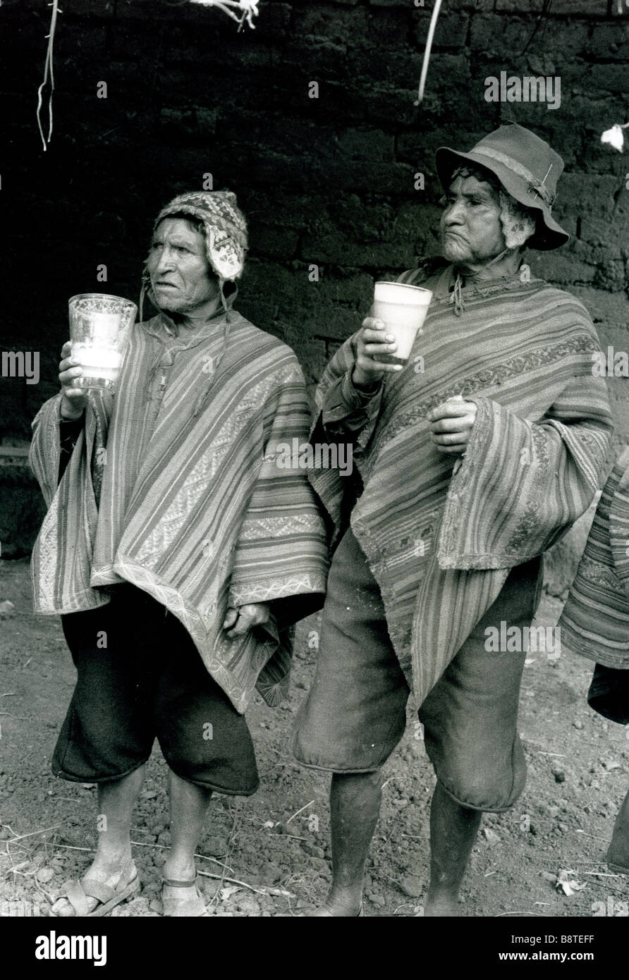 Peru. Native Quechua men drinking 'chicha' fermented maize beer in the ...