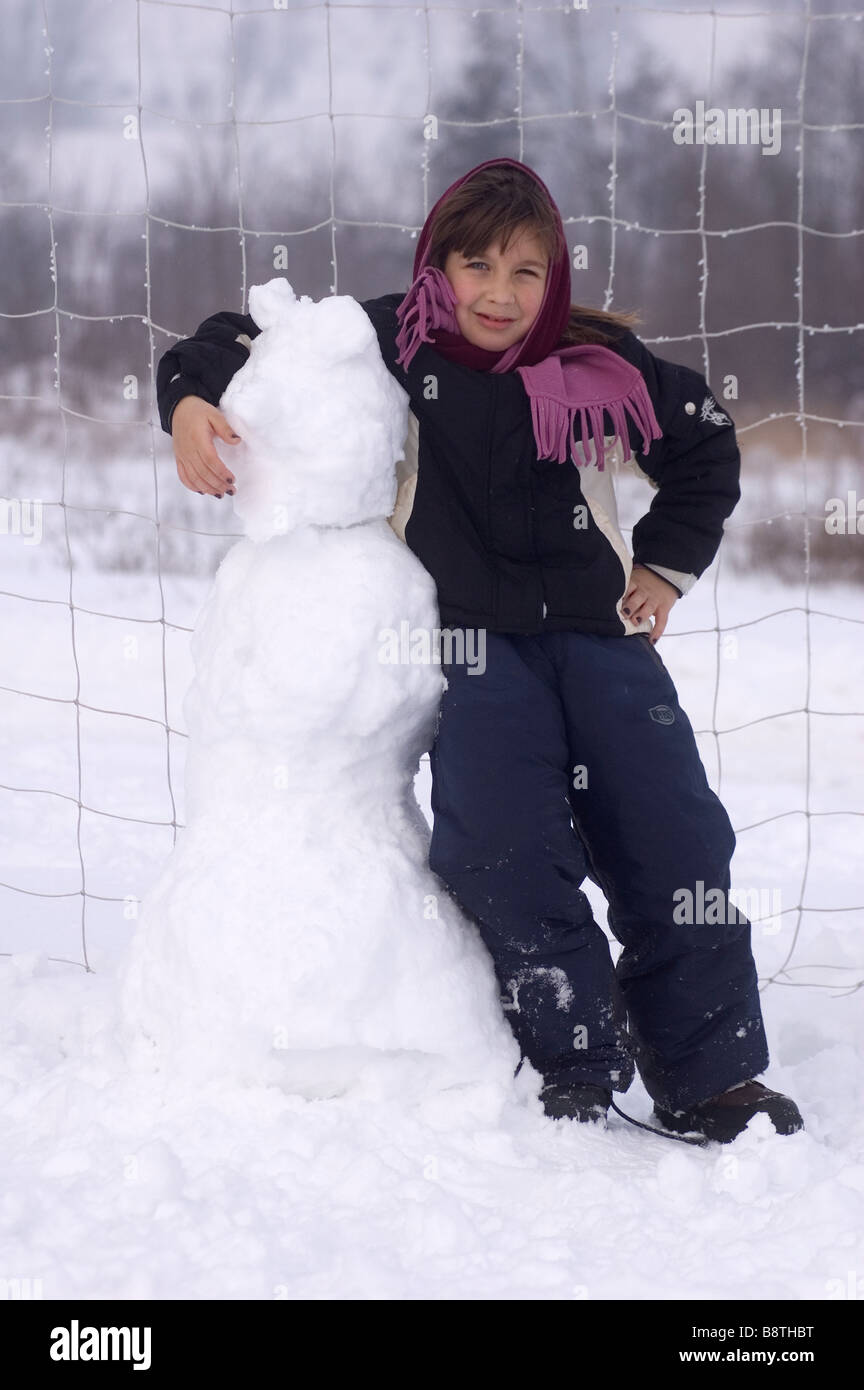 Girl hugging snowman Stock Photo - Alamy