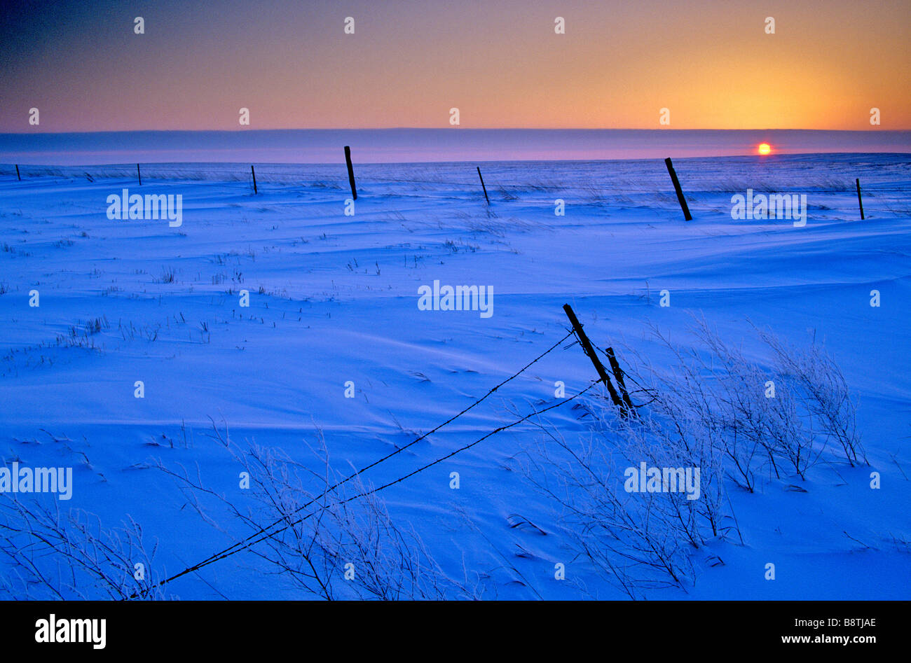 Sunset over snowy fields winter on Northern Great Plains in Mercer ...