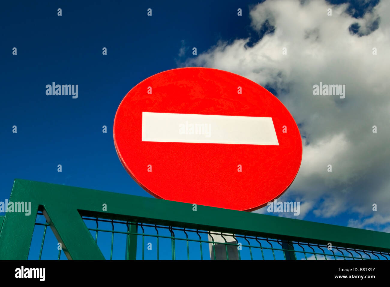 Concept Red No Entry sign and blue sky at entrance to secure metal ...