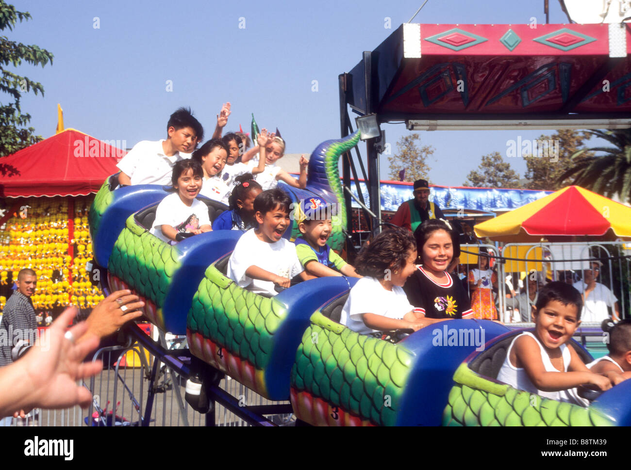 kids ride carnival dragon thrill fun excite laugh scream speed danger ...