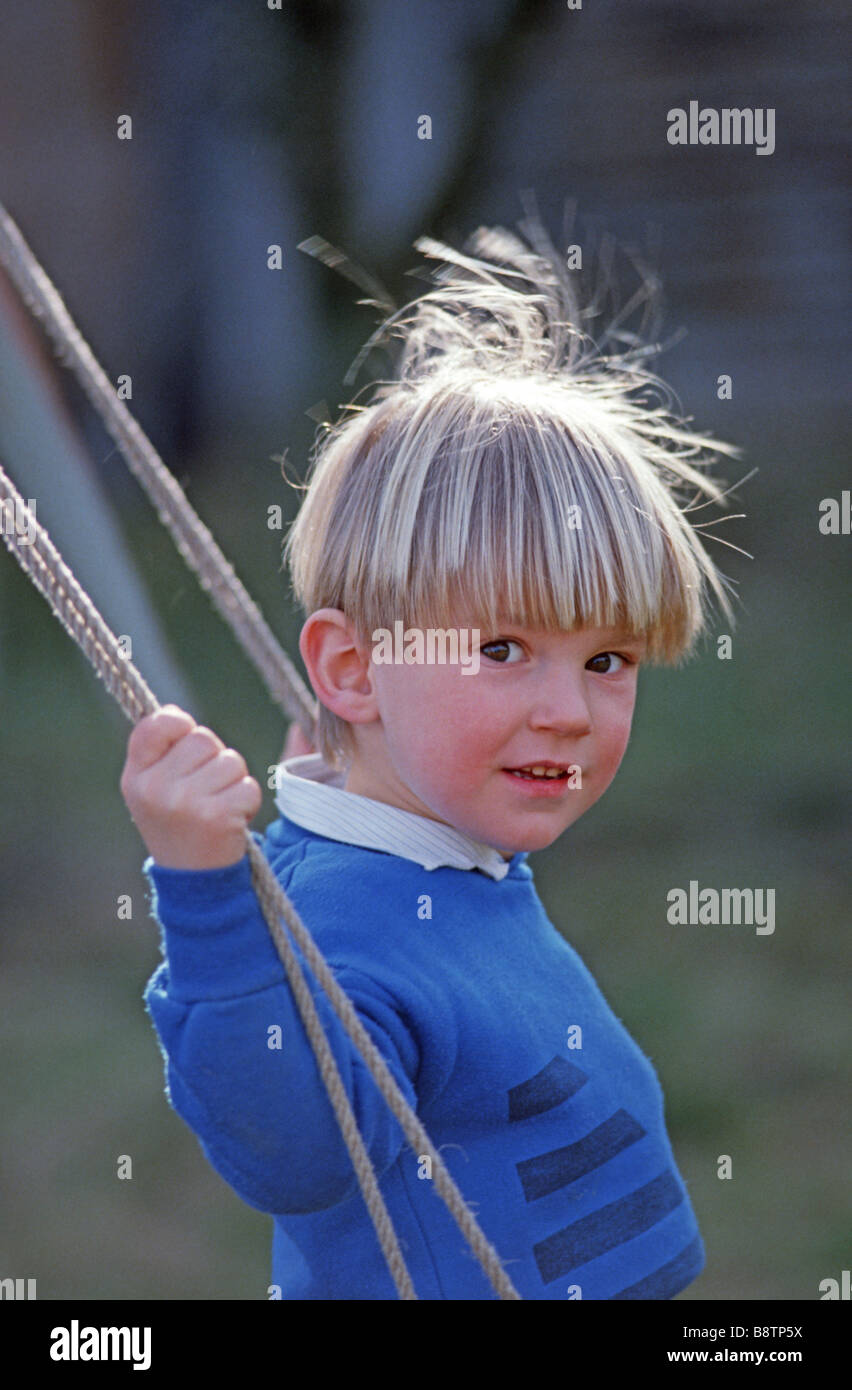 blond boy on swing, Germany Stock Photo - Alamy