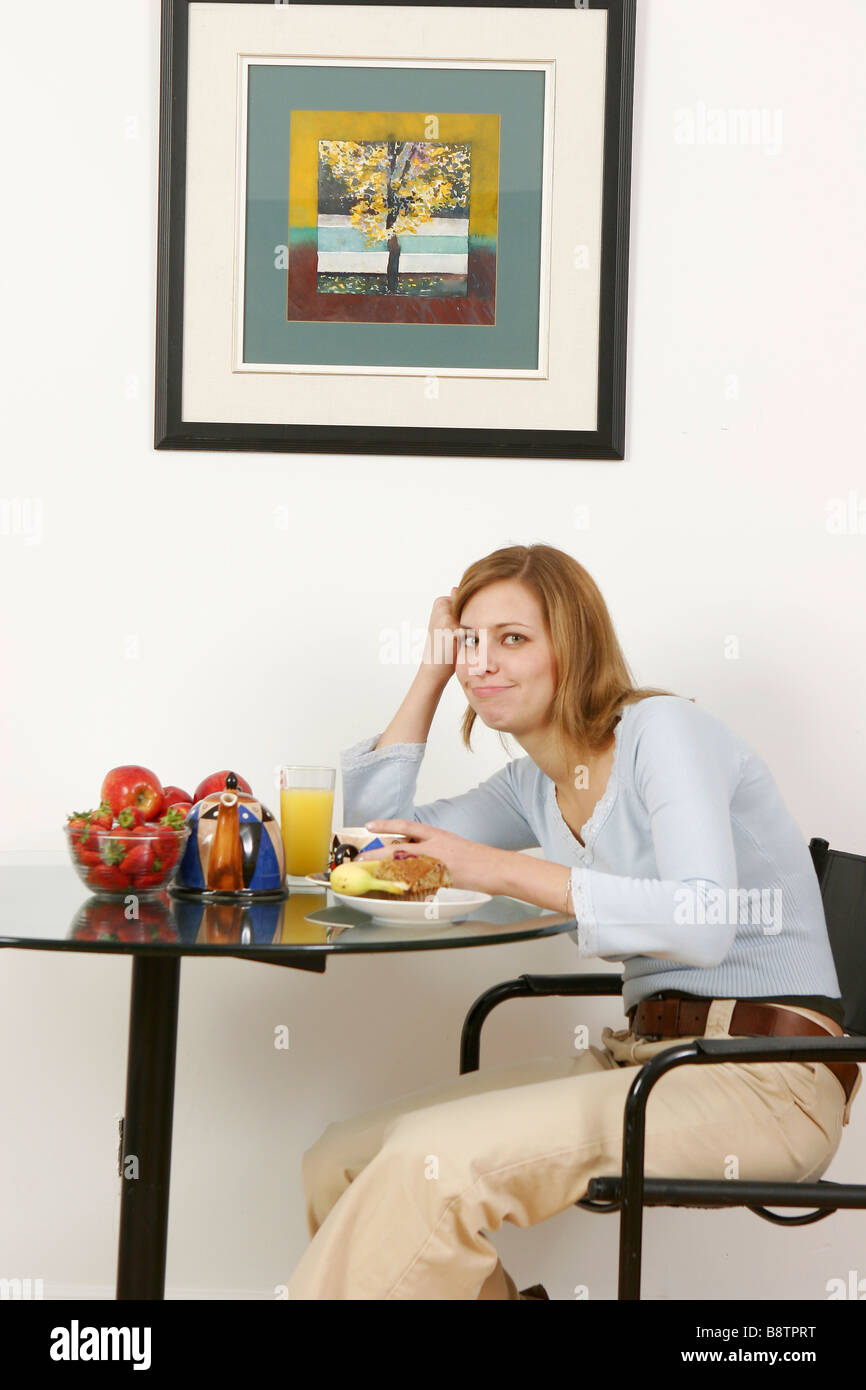Woman eating breakfast Stock Photo - Alamy