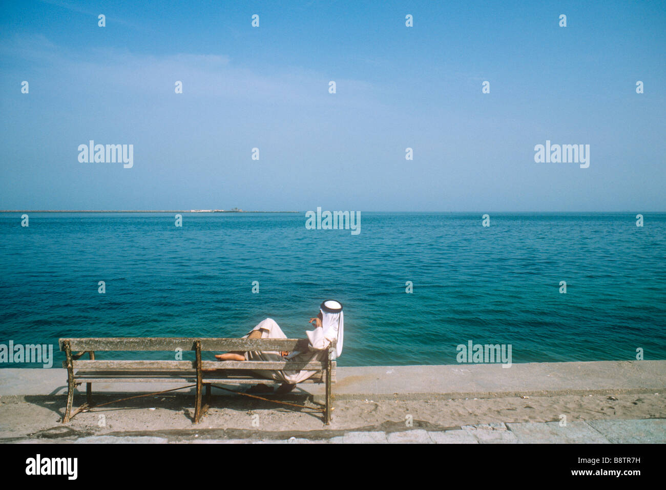 Arab on a seaside bench Abu Dhabi UAE Stock Photo - Alamy