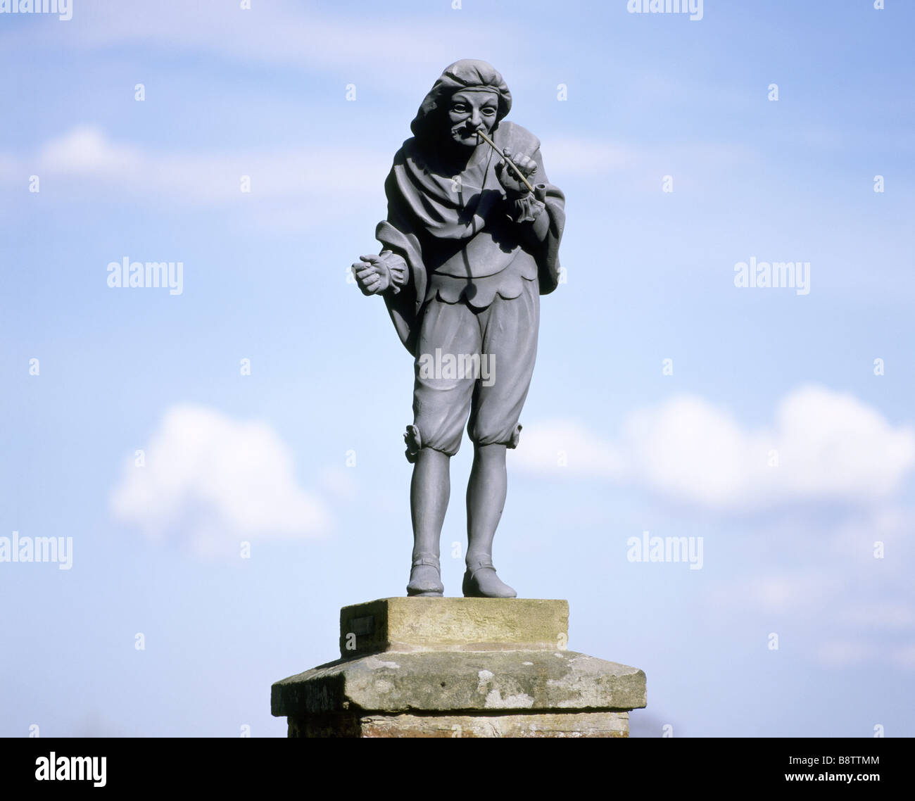 A stone character smoking a pipe in the gardens at Wallington STATUE ...