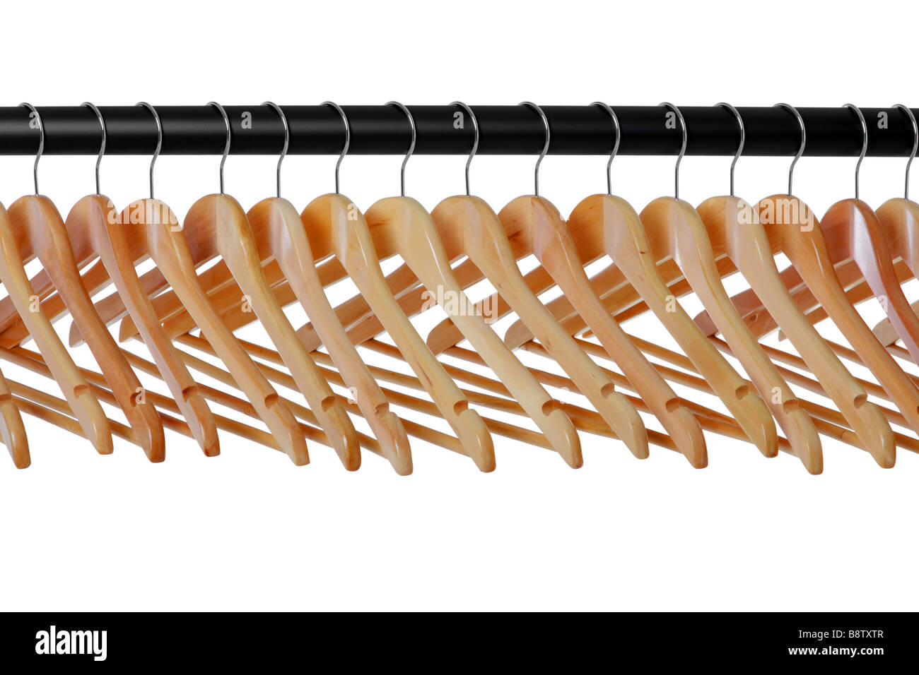 A line of wooden coat hangers on a clothes rail Stock Photo - Alamy