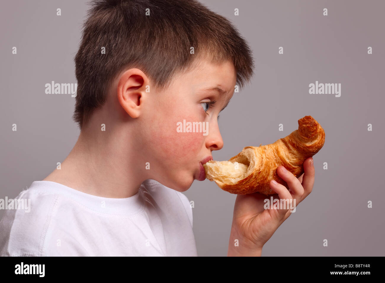 Boy 4 5 eating croissant hi-res stock photography and images - Alamy