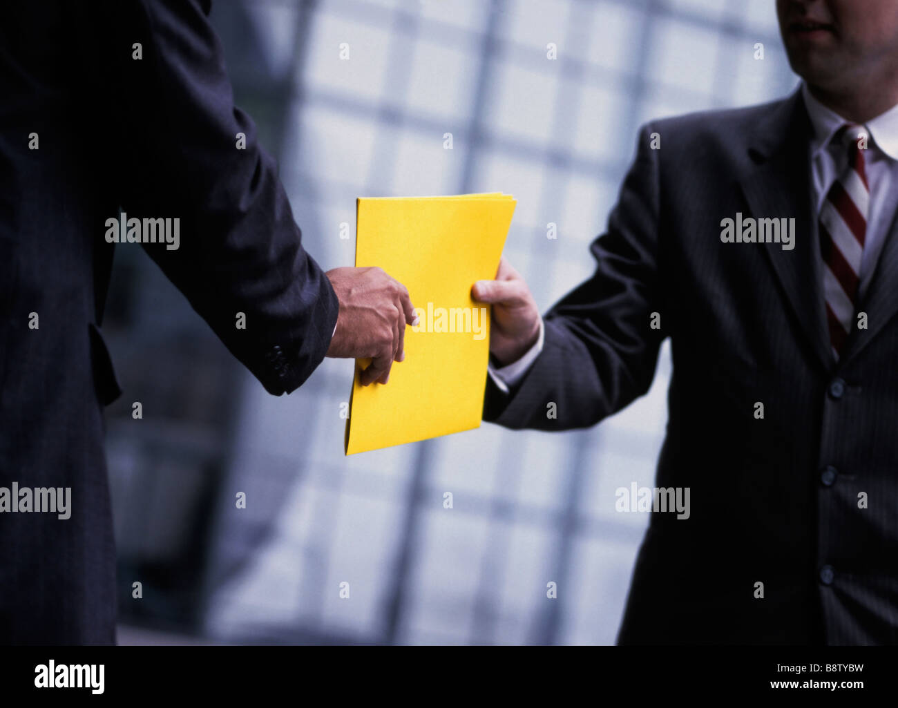 Businessmen passing documents Stock Photo - Alamy