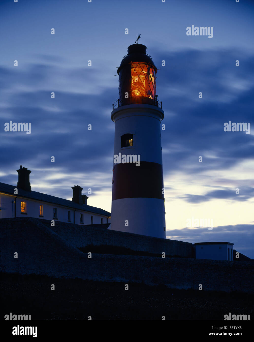 The Lighthouse at Souter showing a red light at dusk against a dramatic ...