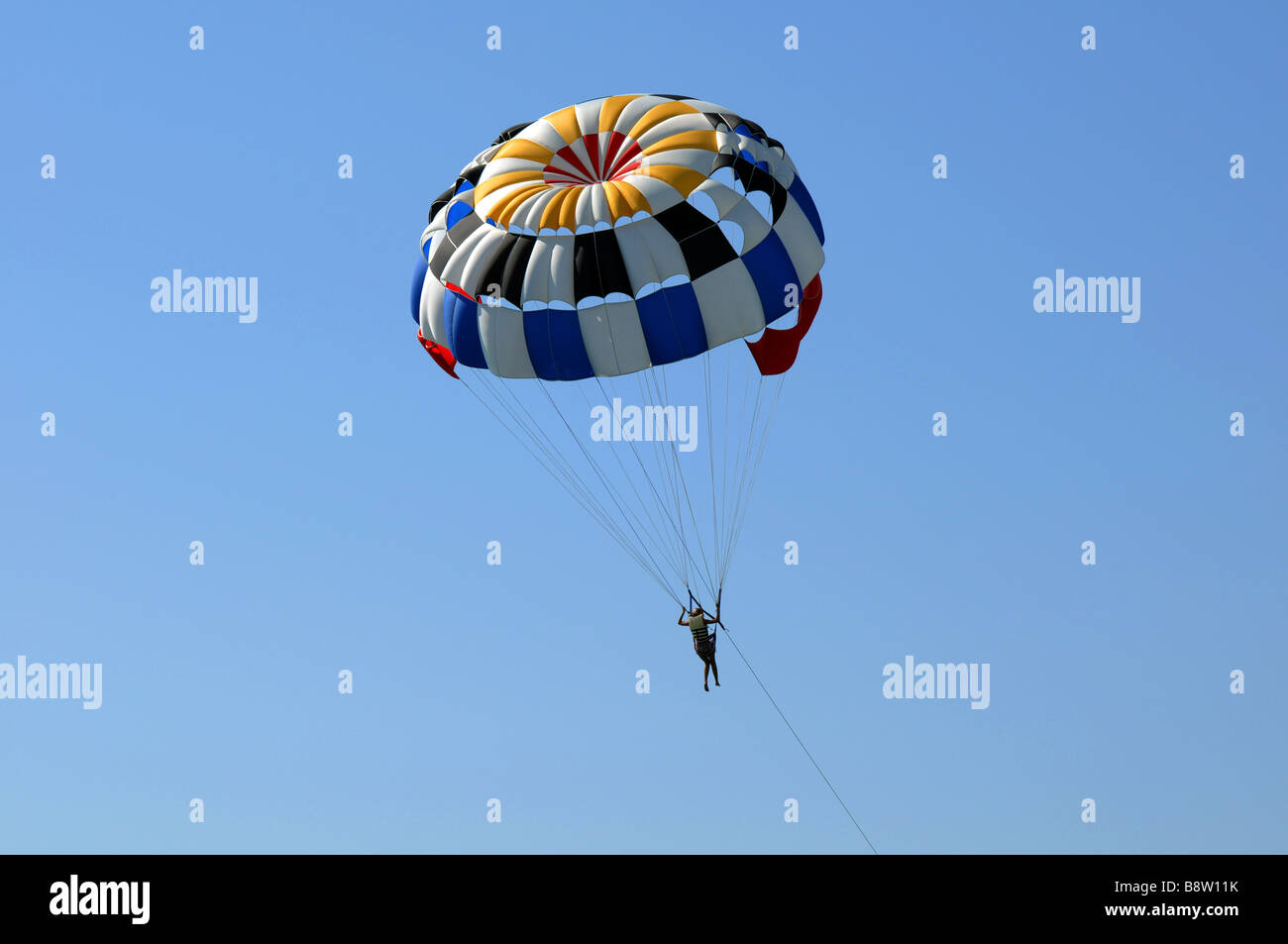 parachute flying in a sky on a blue background Stock Photo - Alamy