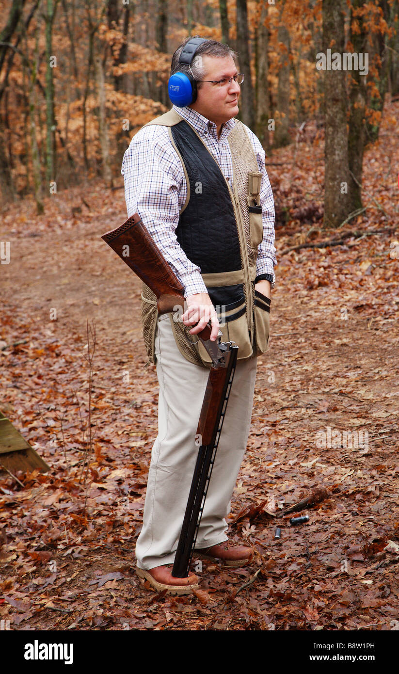 FULL LENGTH VIEW OF SPORTING CLAY SHOOTER GUN BROKEN OPEN POINTING DOWN ...