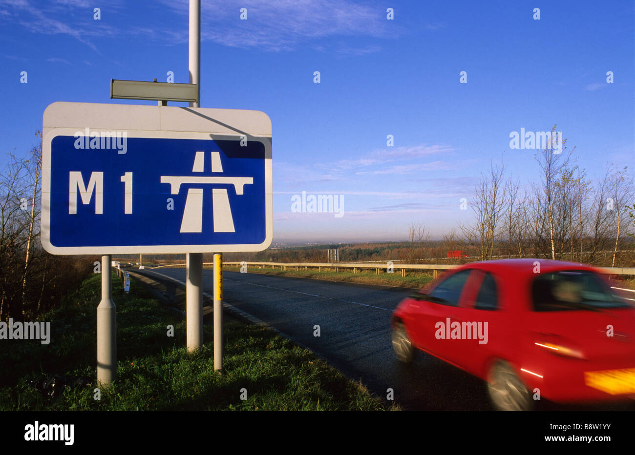 car passing road sign stating start of M1 motorway near Leeds Yorkshire ...
