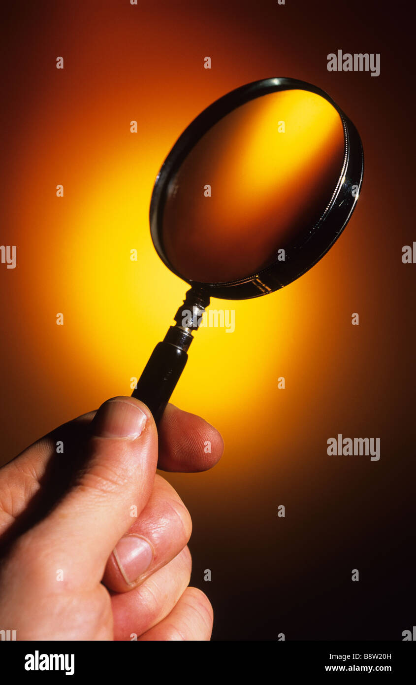 hand holding magnifying glass Stock Photo - Alamy