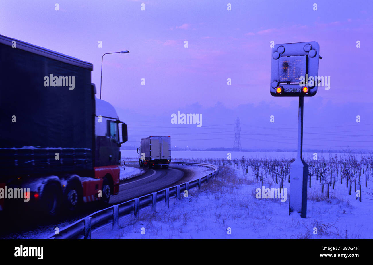 lorries passing warning sign of reduced speed limit on motorway due to ...