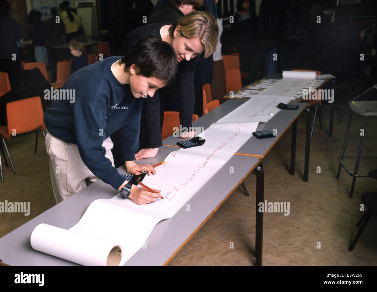 Primary school boy working on a mathematical equations for a school ...