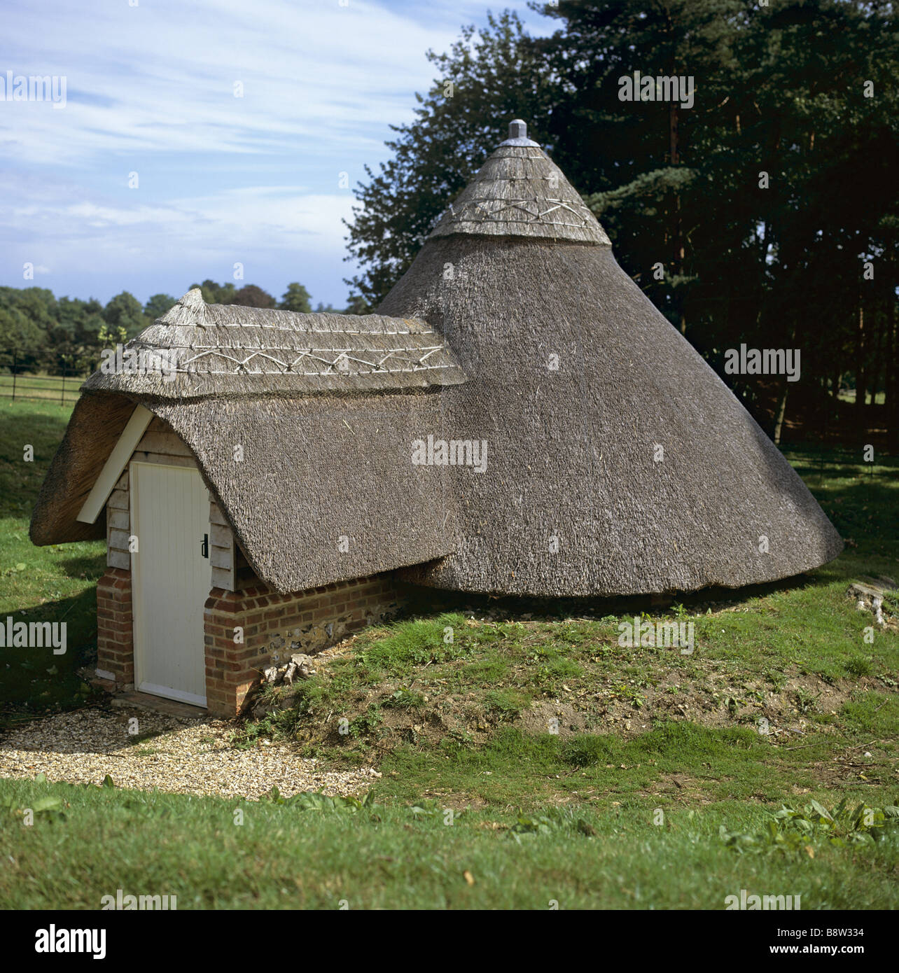 View of the thatched restored c19th Ice house The roof covers a brick ...