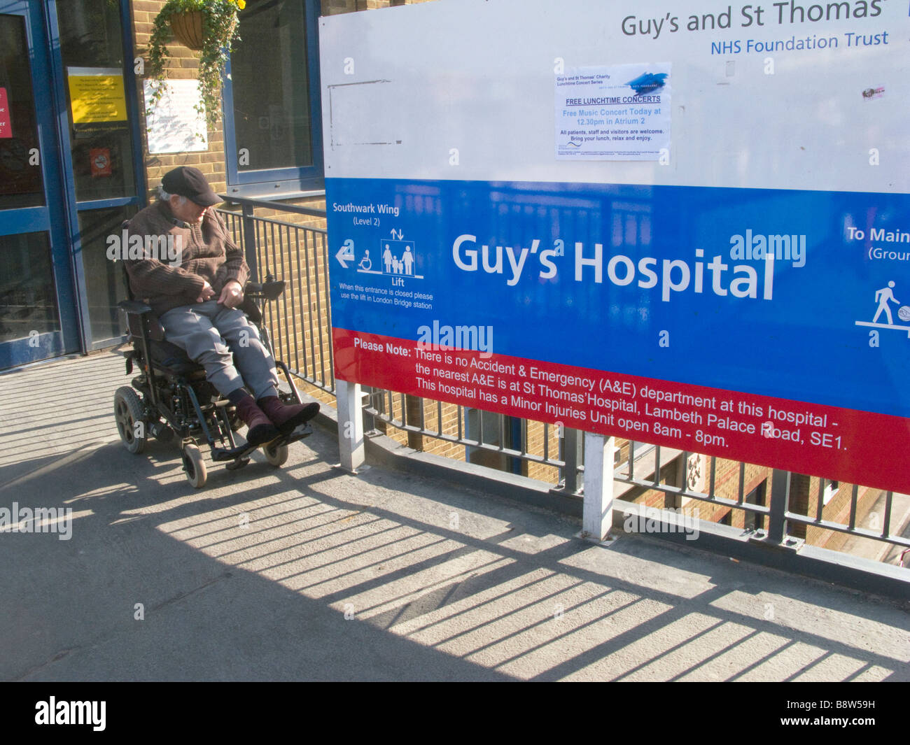 UK.Man with disability outside Guys and St.Thomas hospital entrance ...